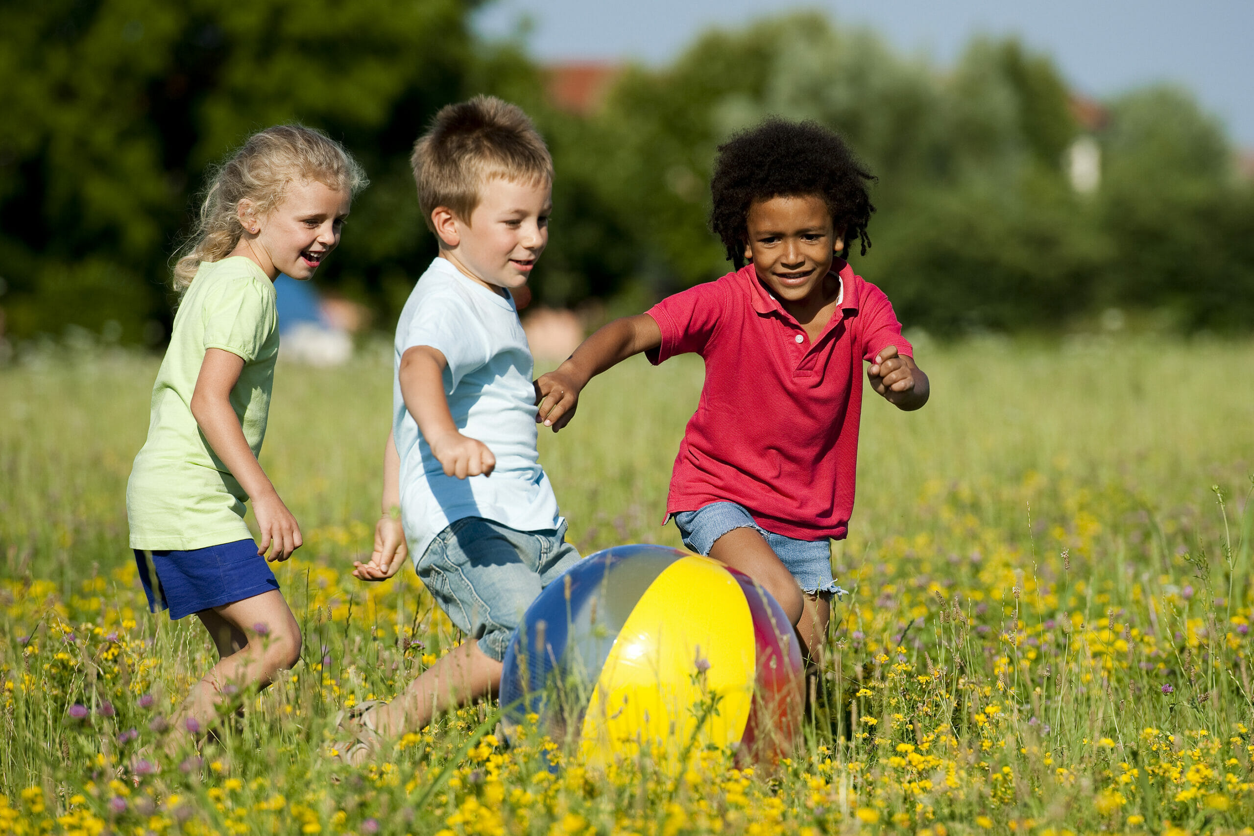 Multi-ethnic children playing ball - KC Our Health Matters